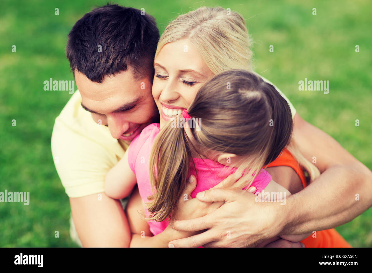 happy family hugging outdoors Stock Photo - Alamy