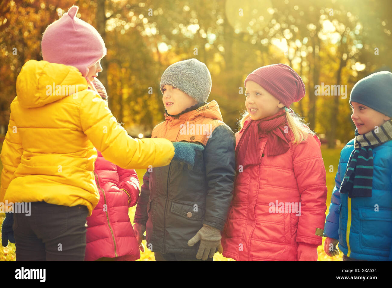 kids in autumn park counting and choosing leader Stock Photo - Alamy
