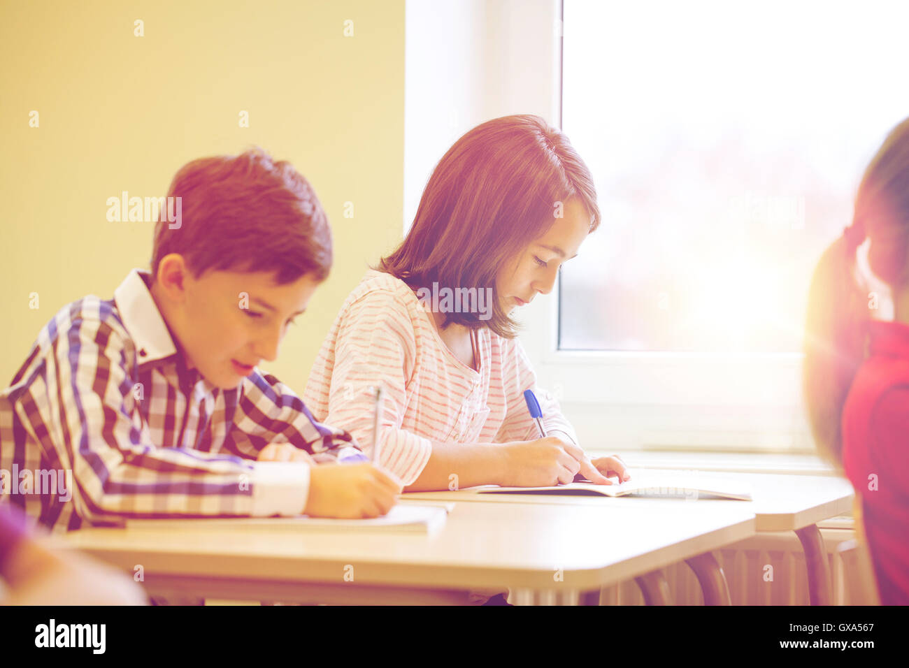 group of school kids writing test in classroom Stock Photo - Alamy