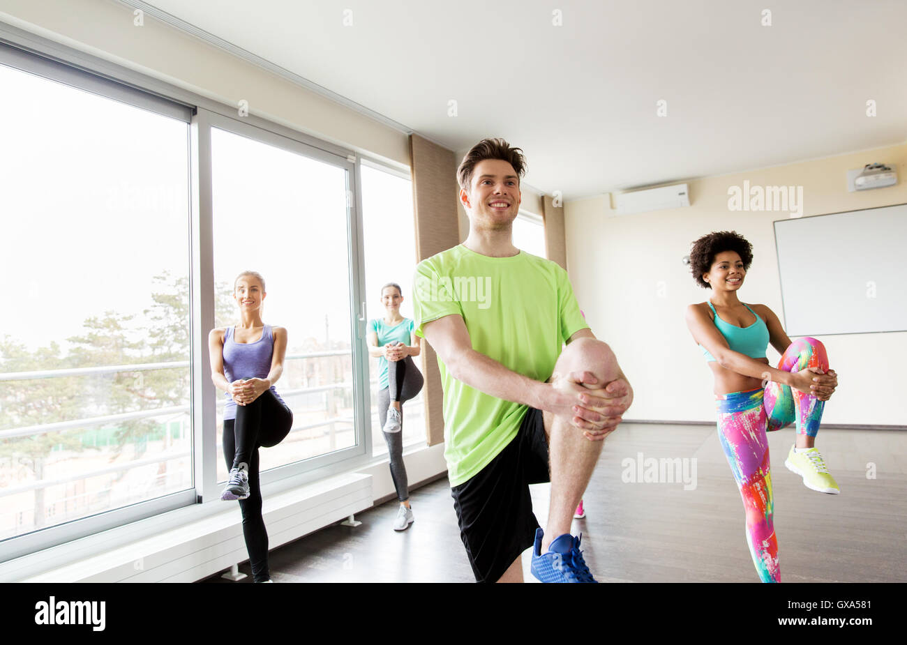 group of smiling people exercising in gym Stock Photo - Alamy