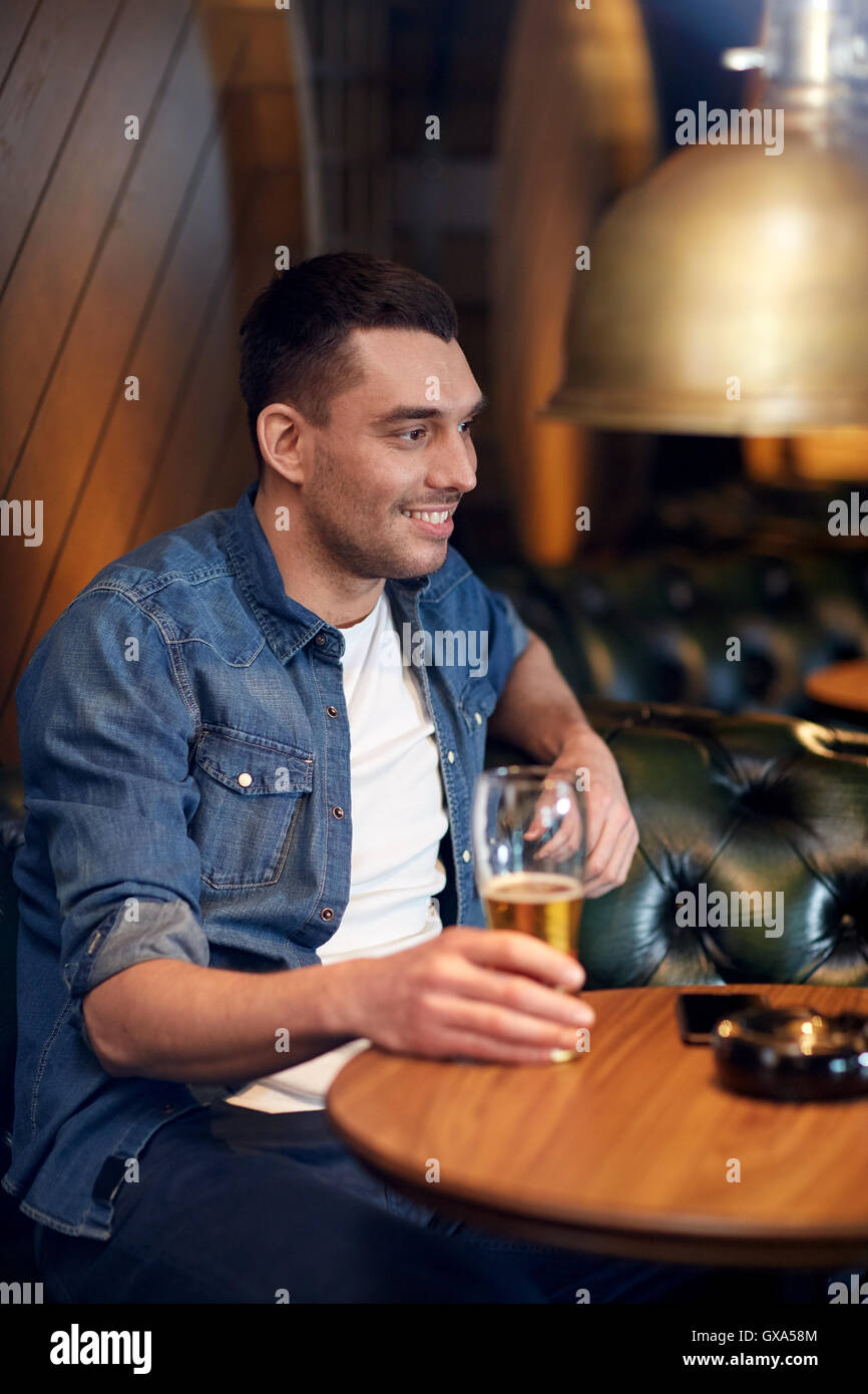 happy man drinking draft beer at bar or pub Stock Photo - Alamy