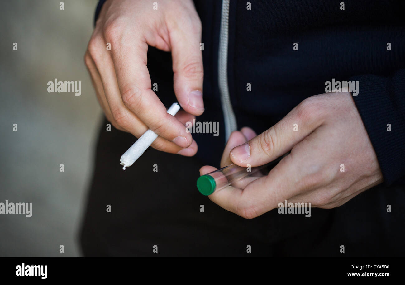 close up of addict hands with marijuana joint tube Stock Photo - Alamy