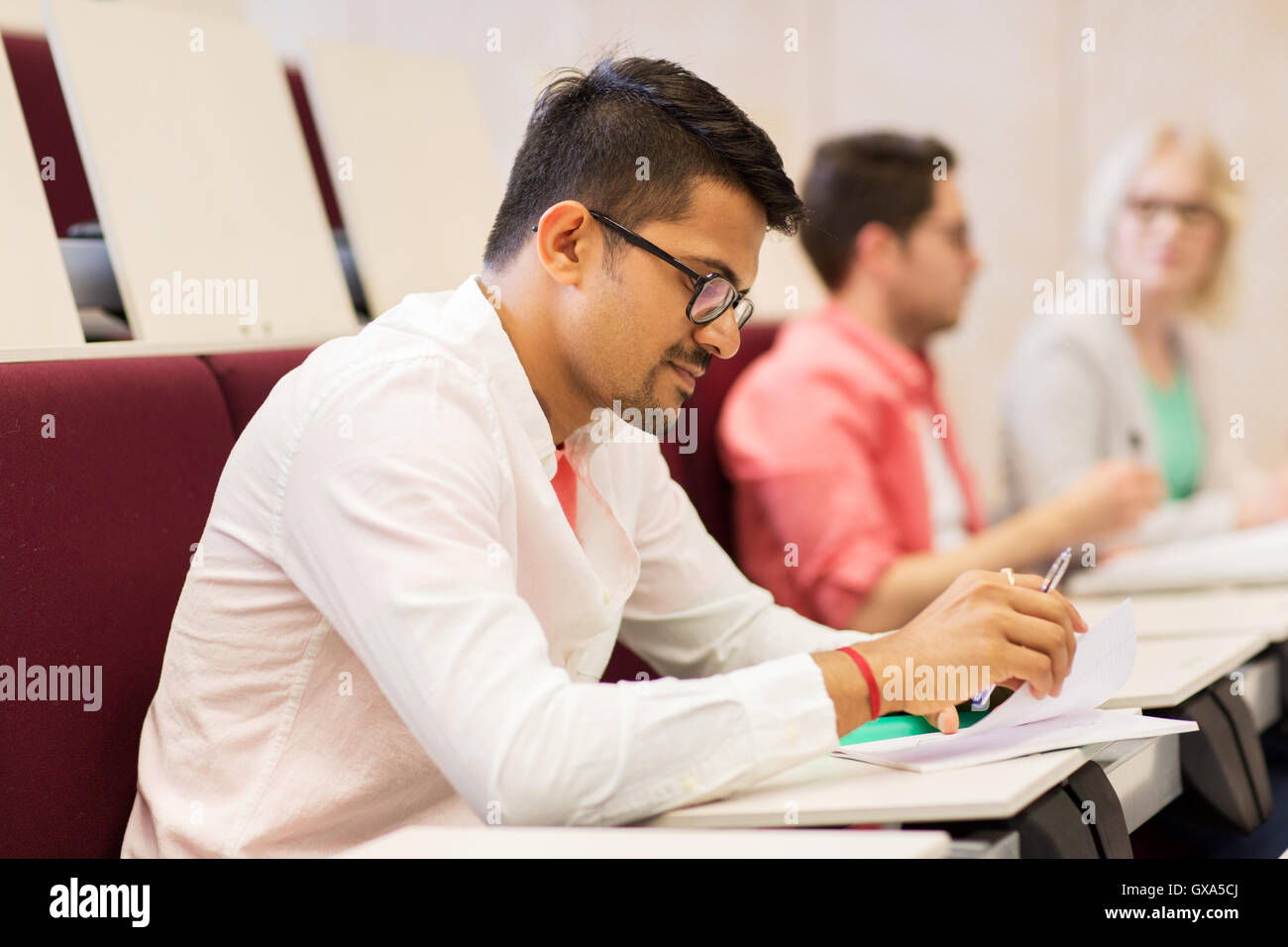 group of students with notebooks in lecture hall Stock Photo - Alamy