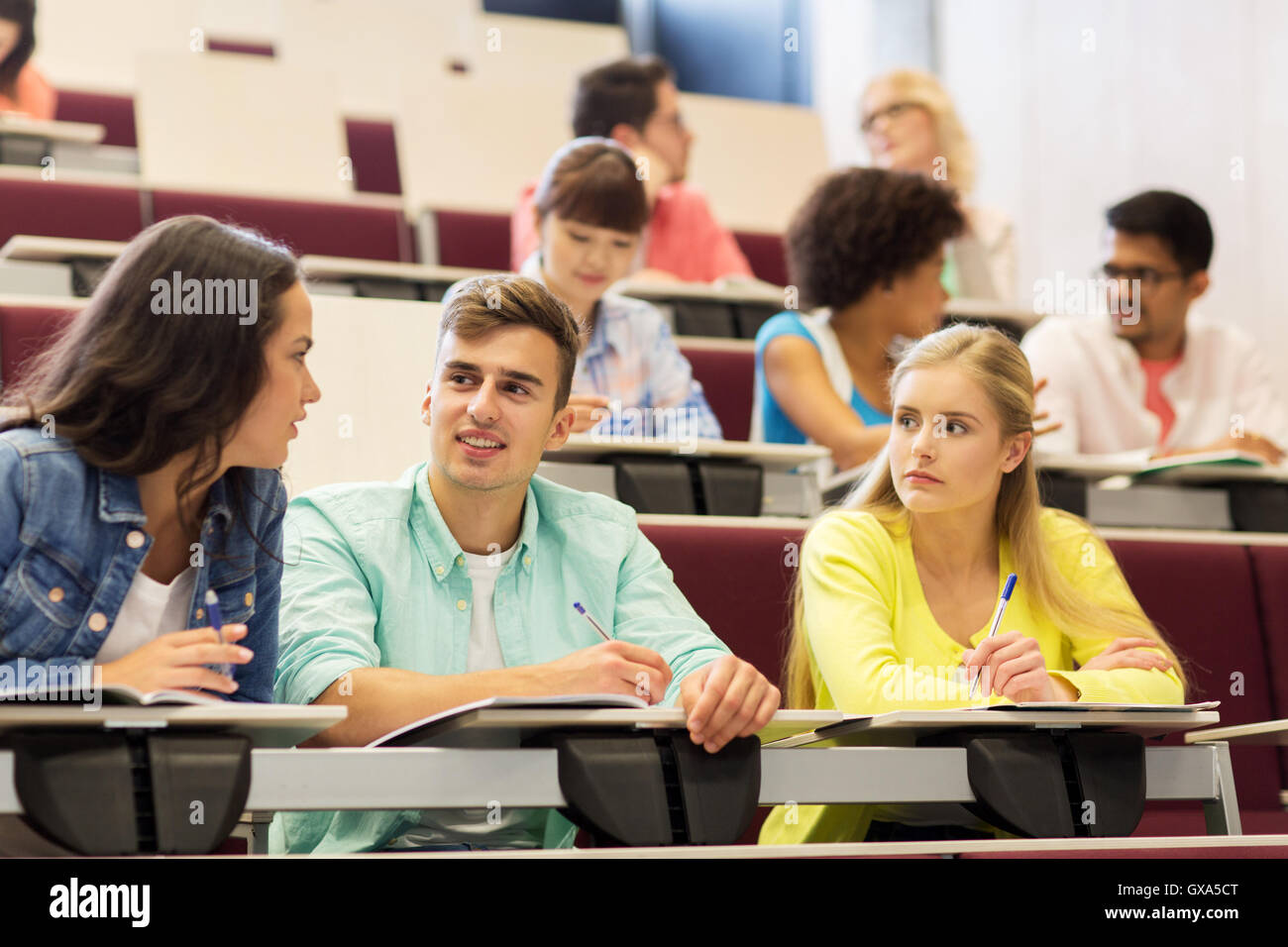 group of students with notebooks in lecture hall Stock Photo - Alamy