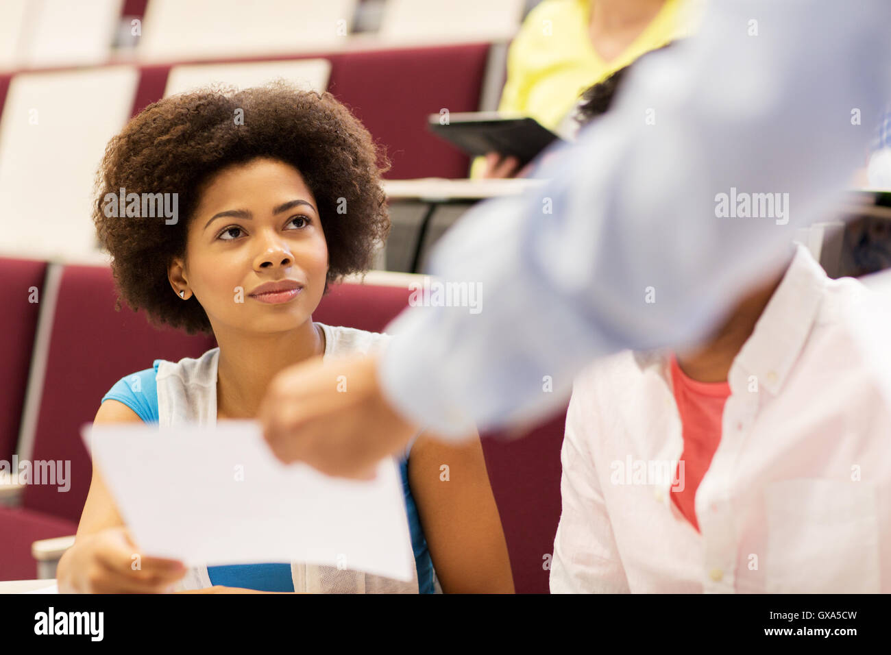 teacher giving test to student girl on lecture Stock Photo - Alamy