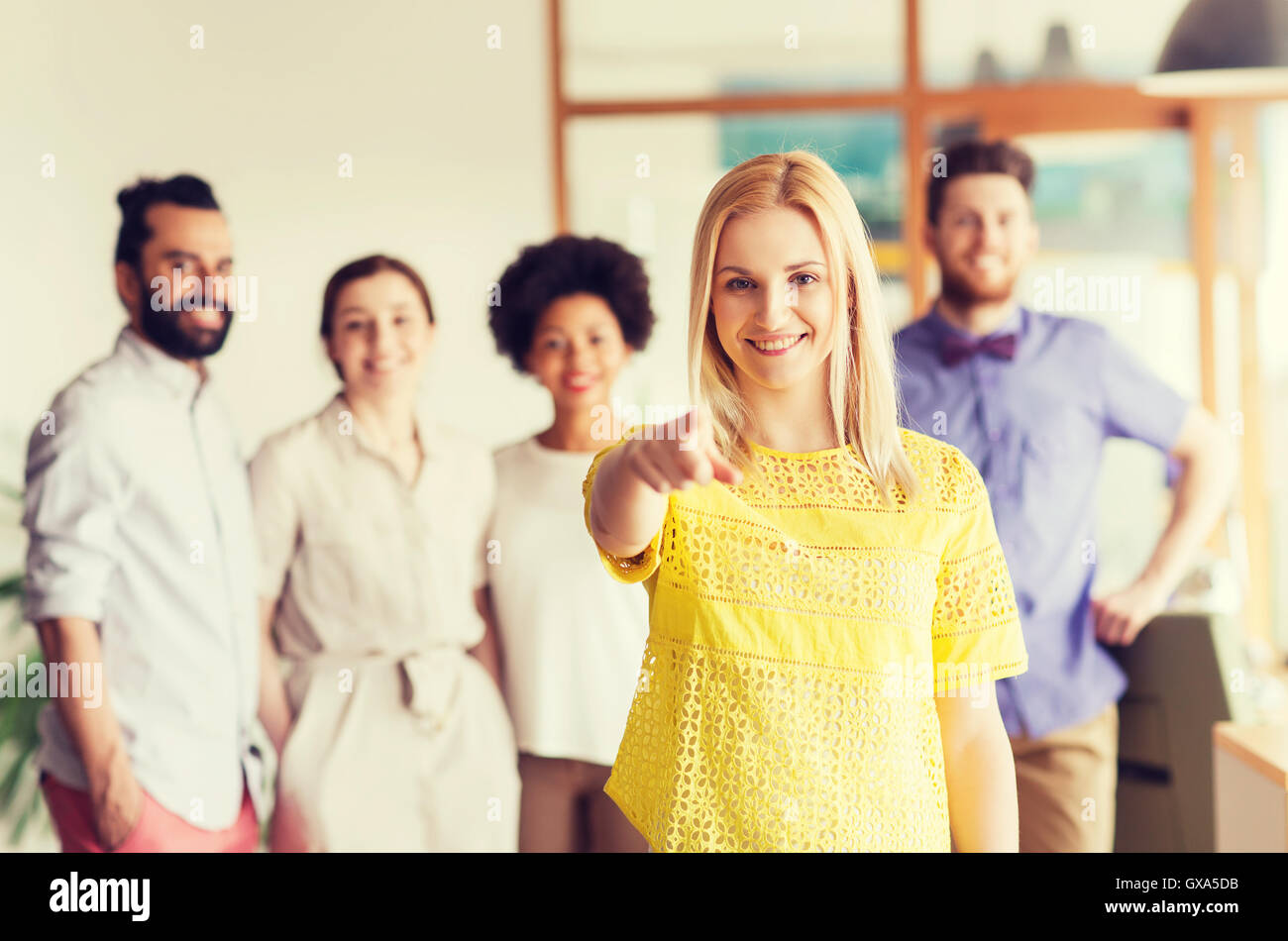 woman pointing to you over creative office team Stock Photo - Alamy