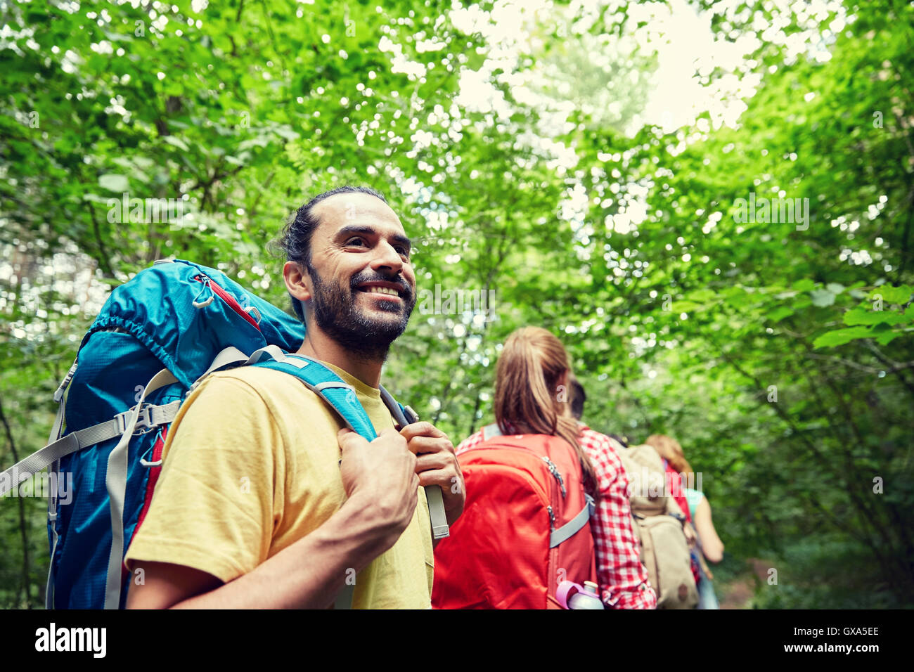 group of smiling friends with backpacks hiking Stock Photo - Alamy
