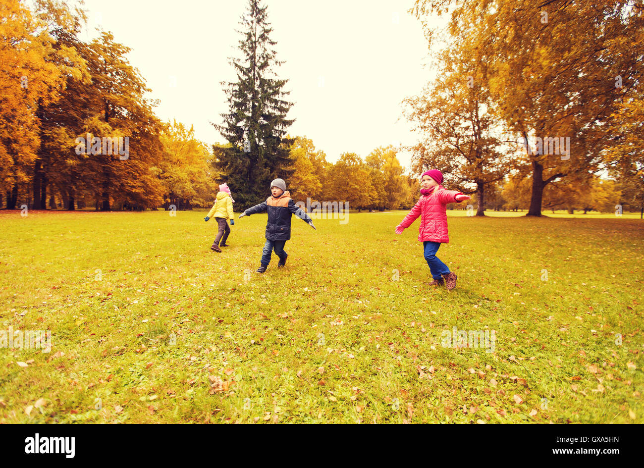 happy little children running and playing outdoors Stock Photo - Alamy