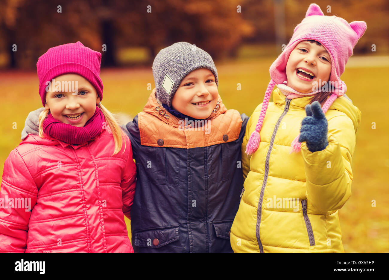 group of happy children hugging in autumn park Stock Photo - Alamy
