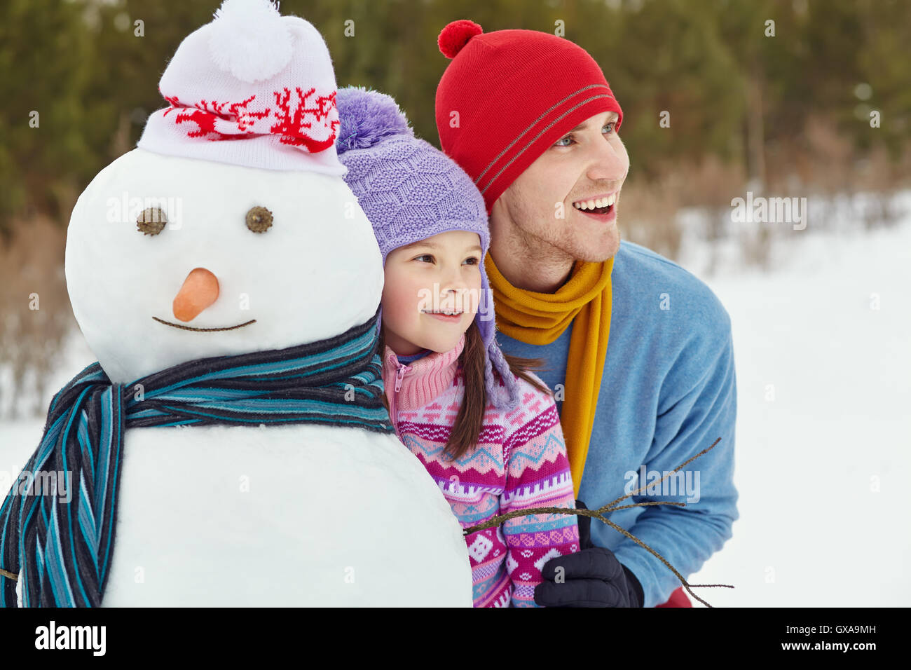 Father and daughter with snowman Stock Photo - Alamy