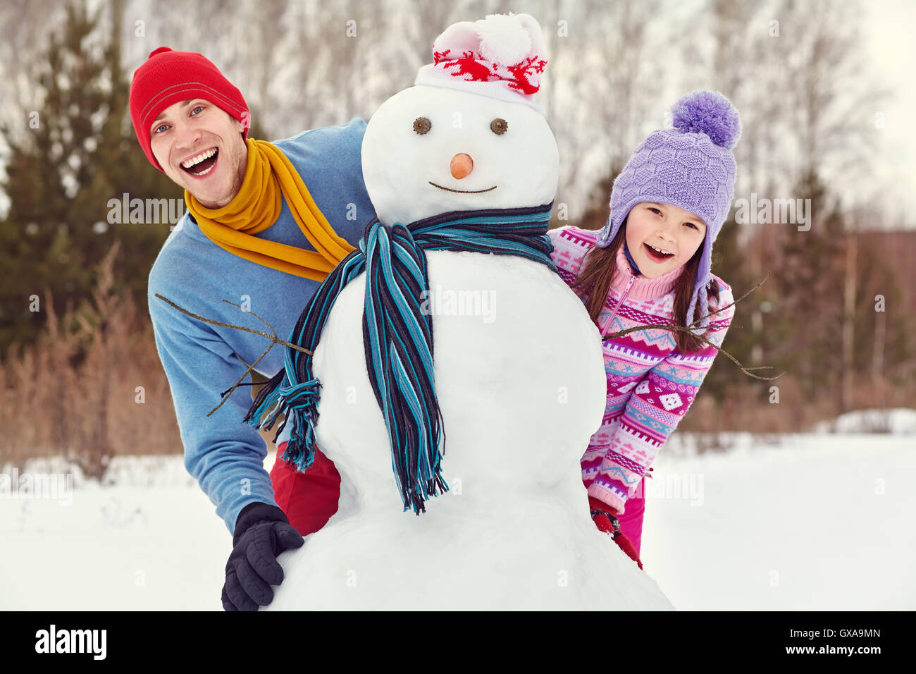 Father and daughter with snowman Stock Photo - Alamy