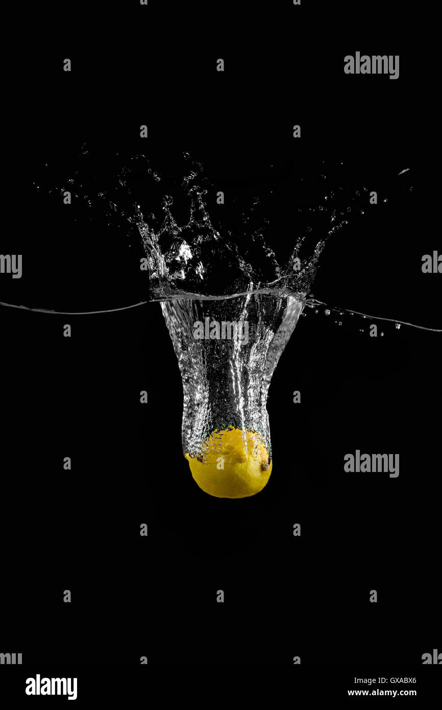 lemon fall in the water on a dark background, and take up a lot of ...