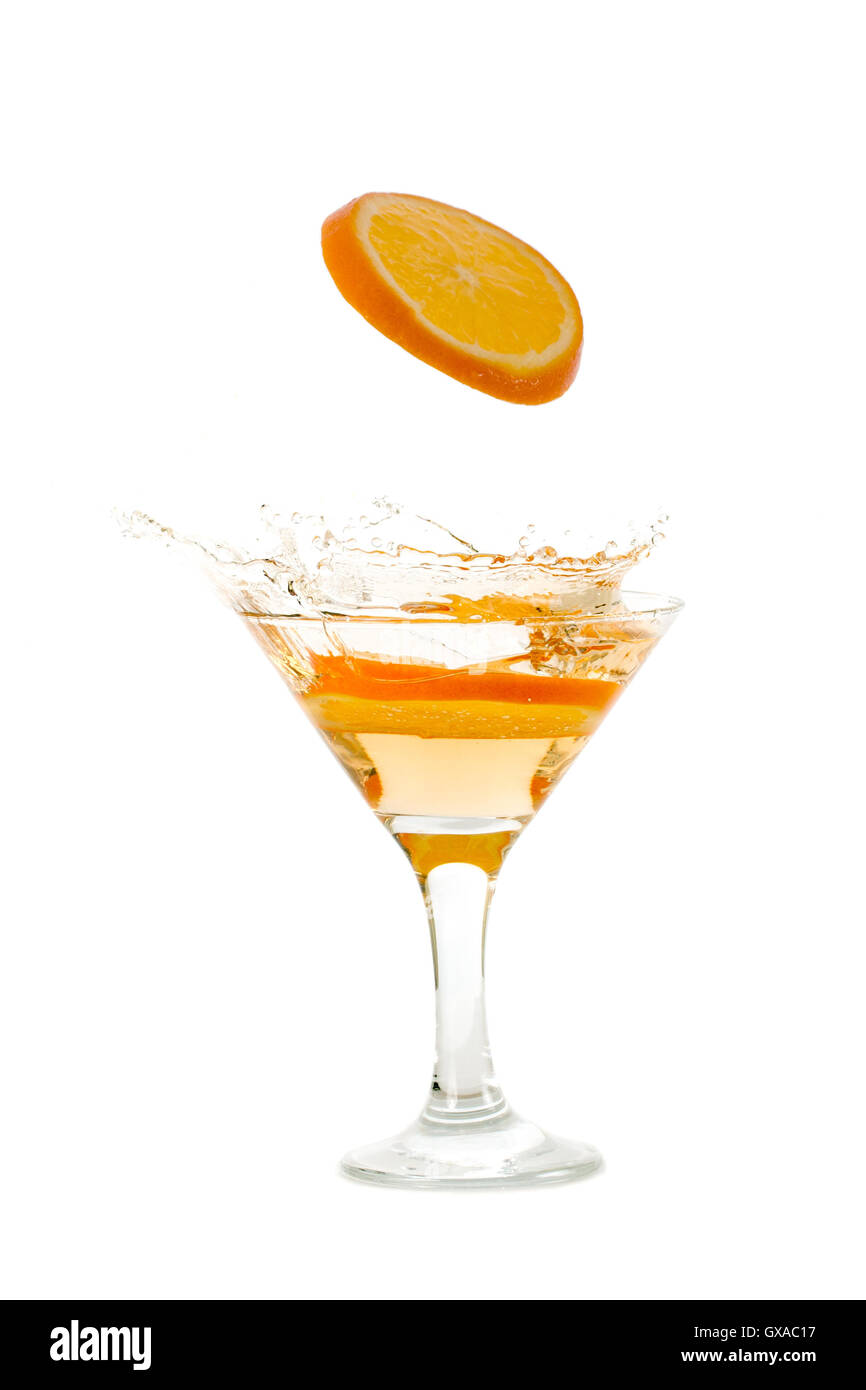orange slice falling into the cocktail and raises a lot of splashing ...