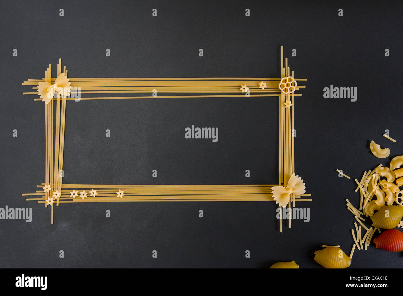 spaghetti and other pasta as a frame on a dark background Stock Photo ...
