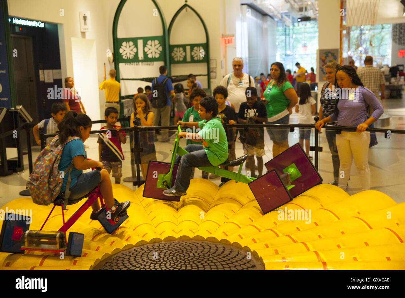 Children and adults explore mathematically based exhibits at the ...