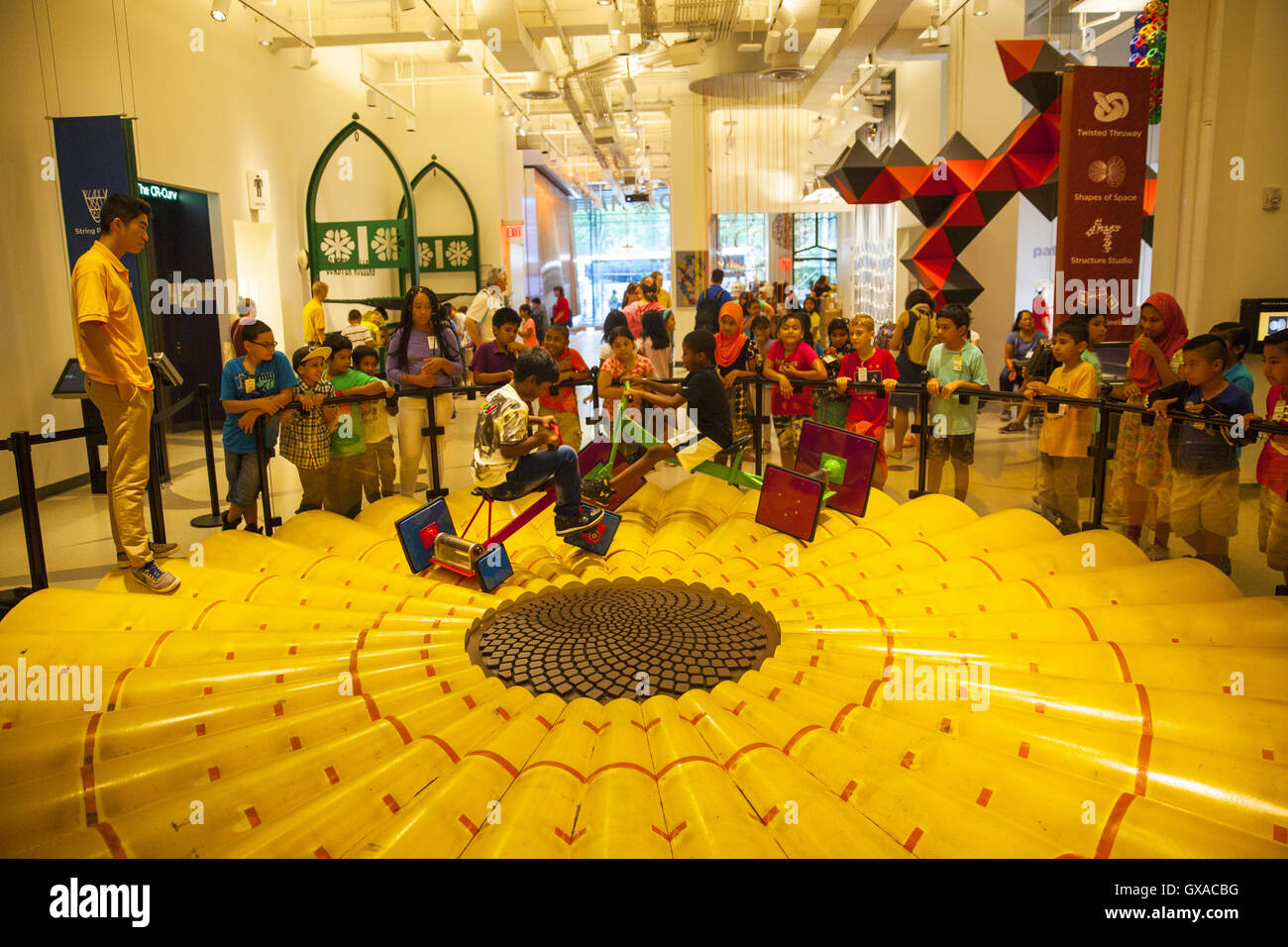 Children and adults explore mathematically based exhibits at the ...