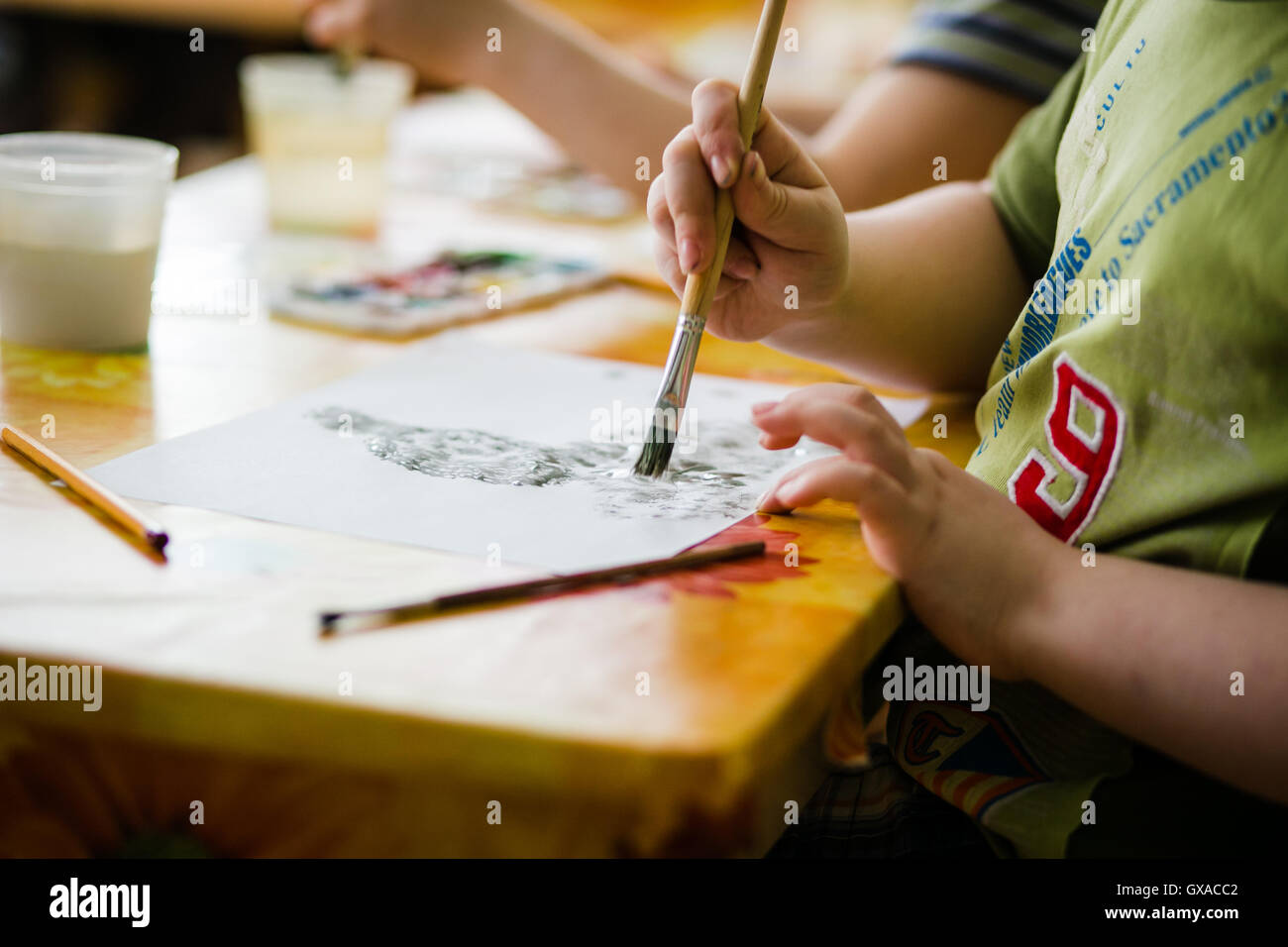the child is painting method of pointing points Stock Photo - Alamy