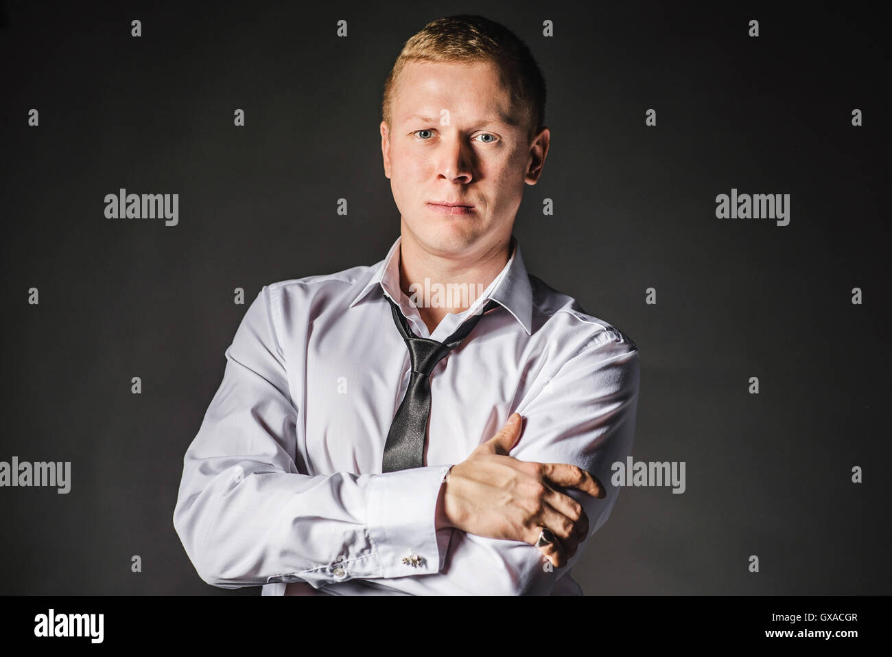 Portrait of serious elegant handsome young man in classic suit toasting ...