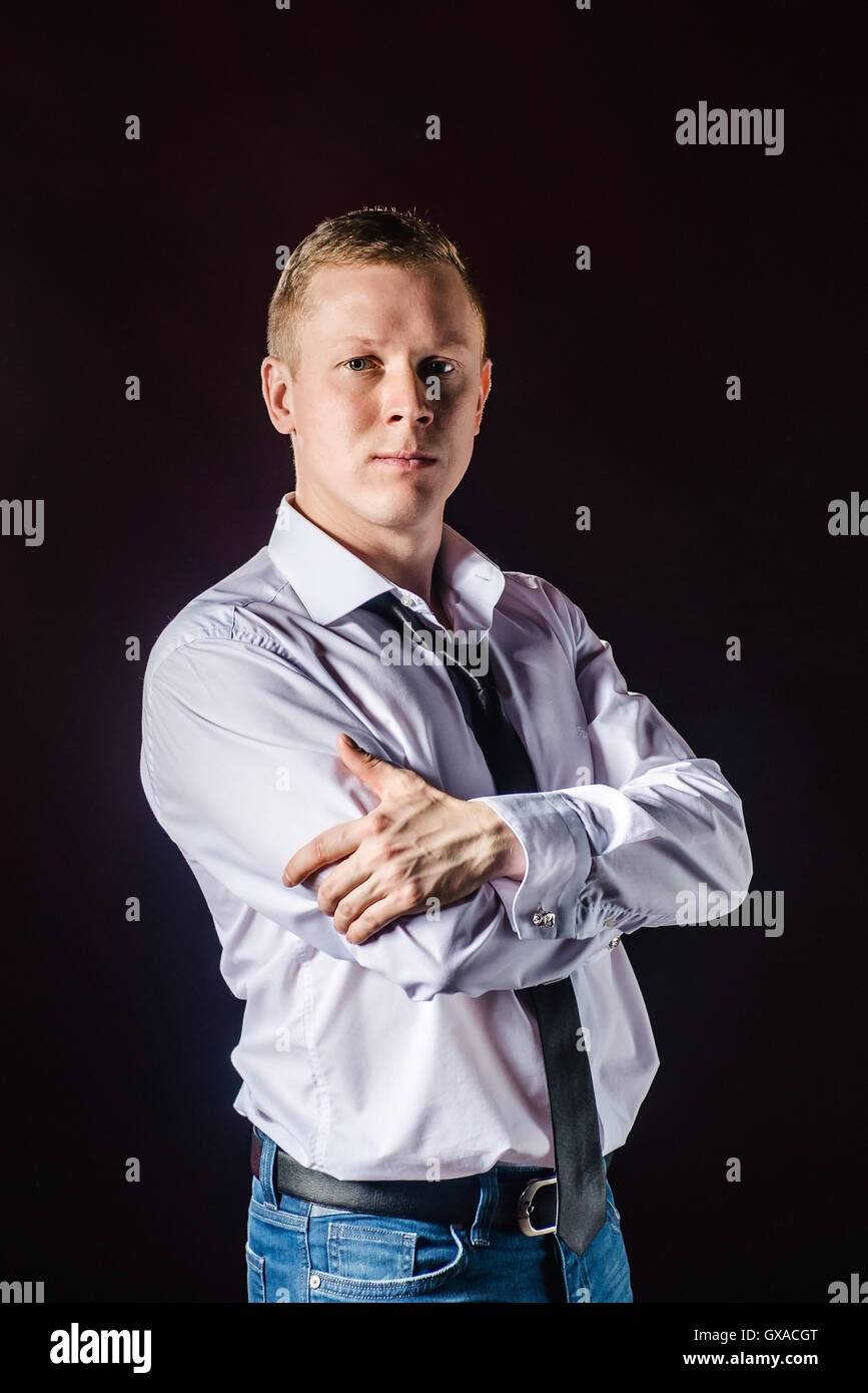 Portrait of serious elegant handsome young man in classic suit toasting ...