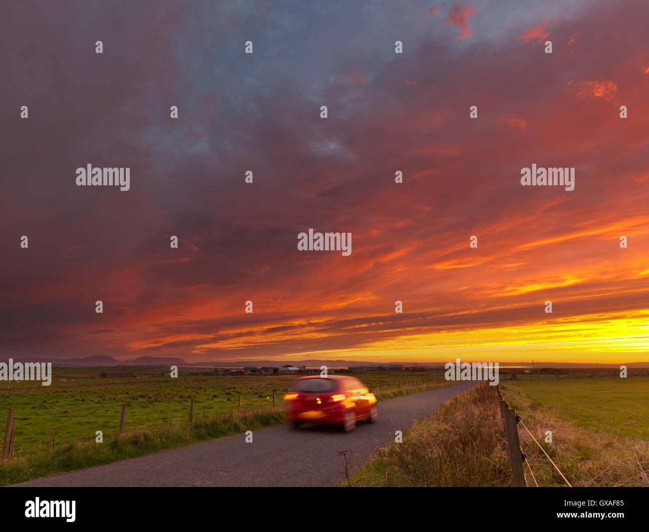 Driving into a sunset Stock Photo - Alamy