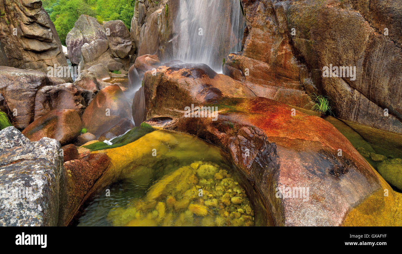 Portugal: Cascade in wild rocky canyon with wet rocks and transparent ...
