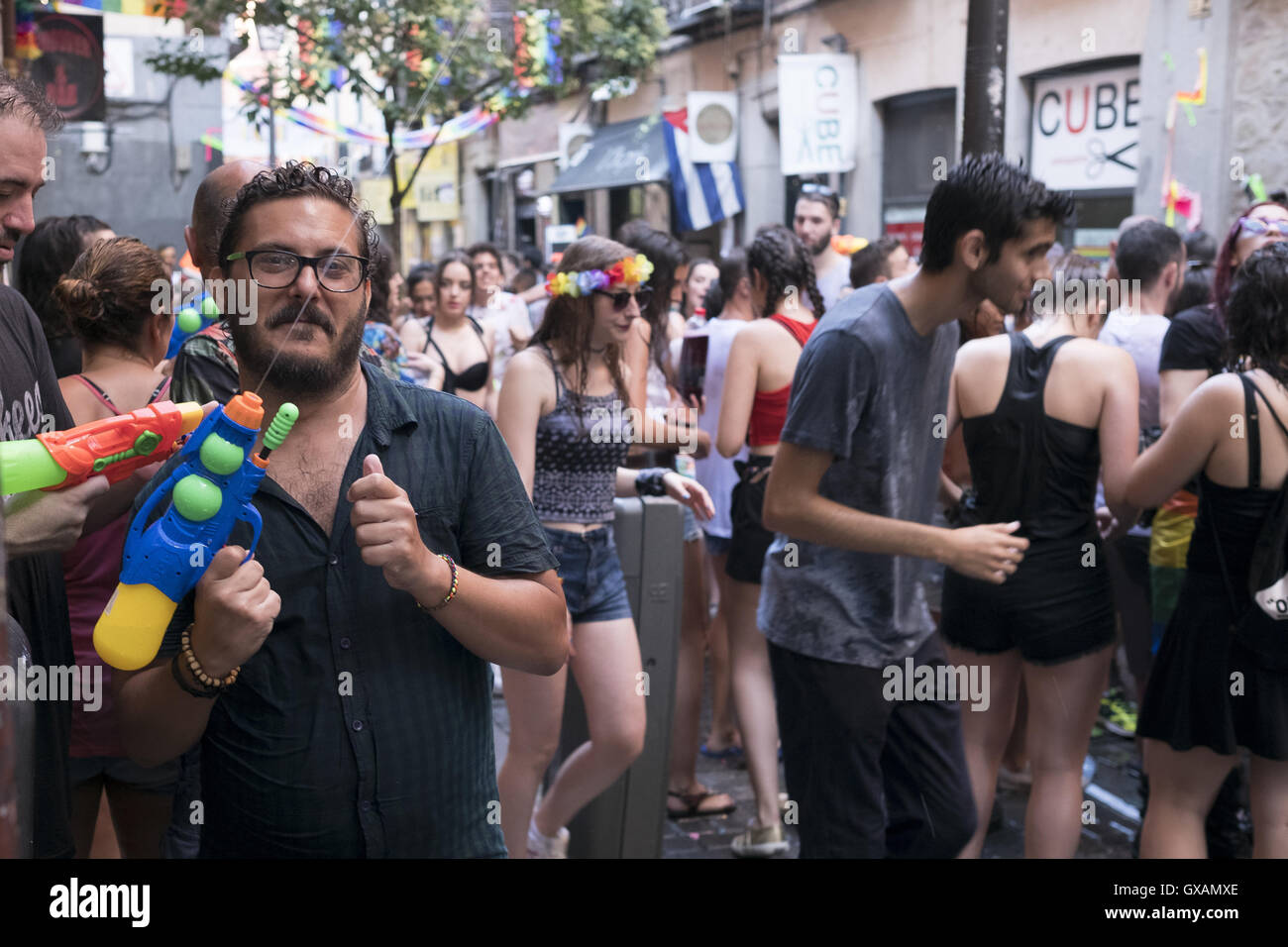 Attendees enjoy the Madrid Pride festivities with a water battle ...