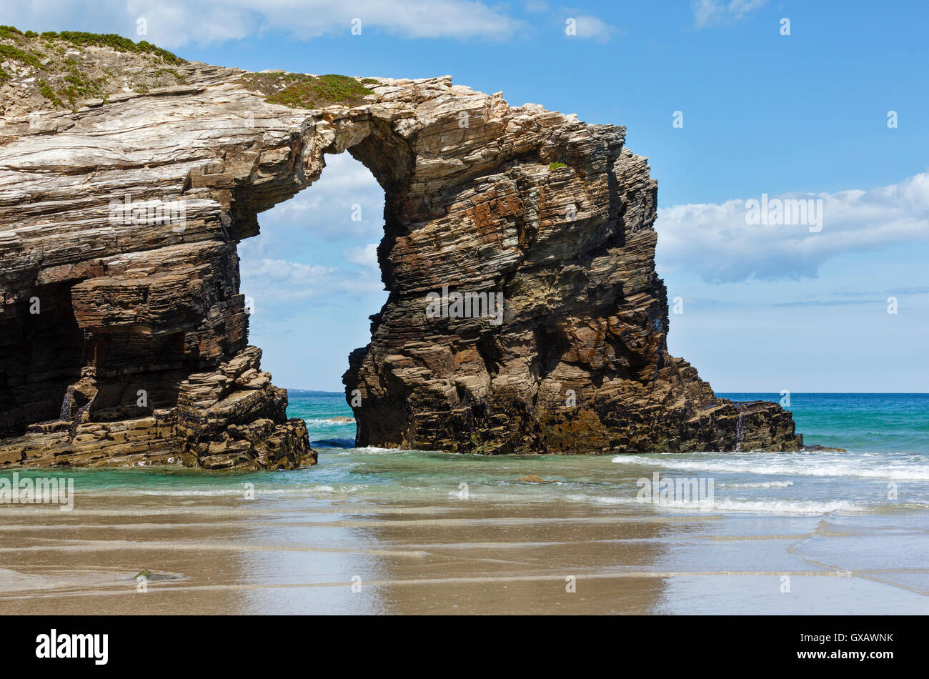 Natural rock arch on Cathedrals beach in low tide (Cantabric coast ...