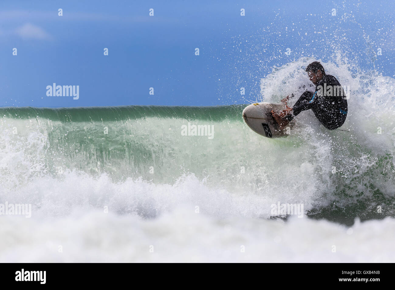 Ride the waves surfing Stock Photo - Alamy