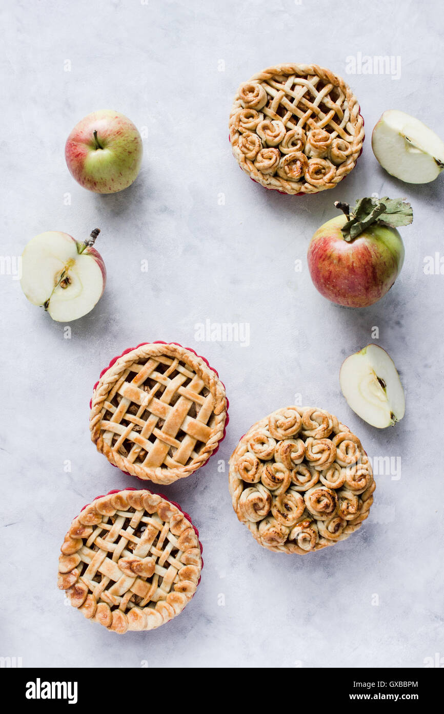 Mini apple pies, decorated with lattice and roses from dough. Top view ...