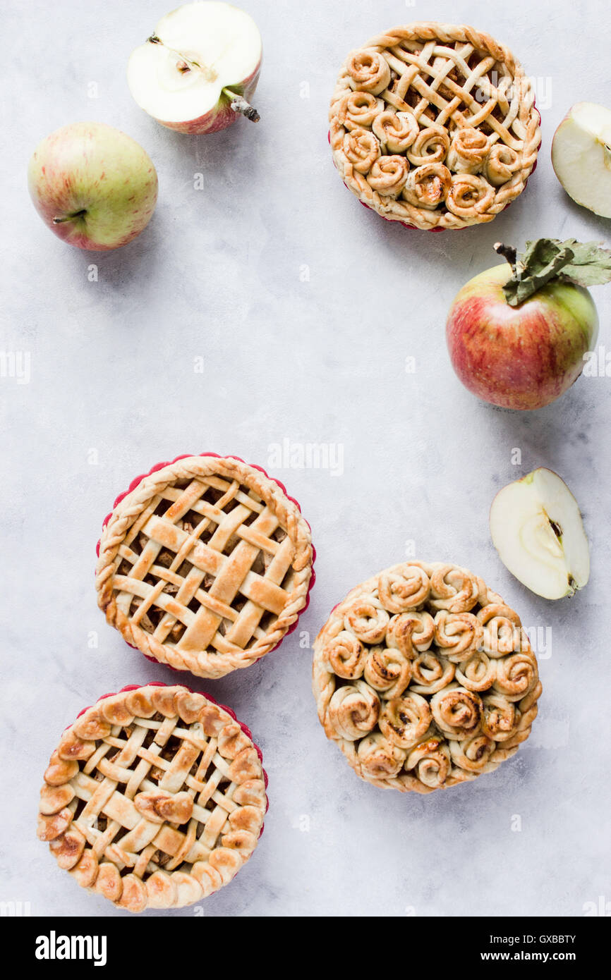 Mini apple pies, decorated with lattice and roses from dough. Top view ...
