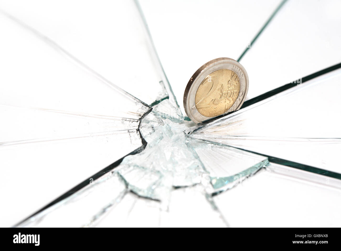 Financial crisis concept. Two Euro coin on shattered glass background ...