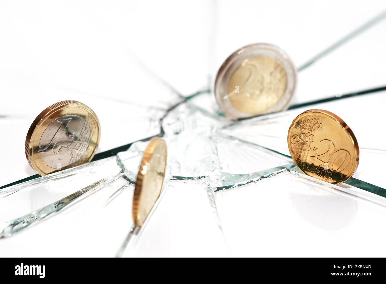 Financial crisis concept. Few Euro coins on shattered glass background ...