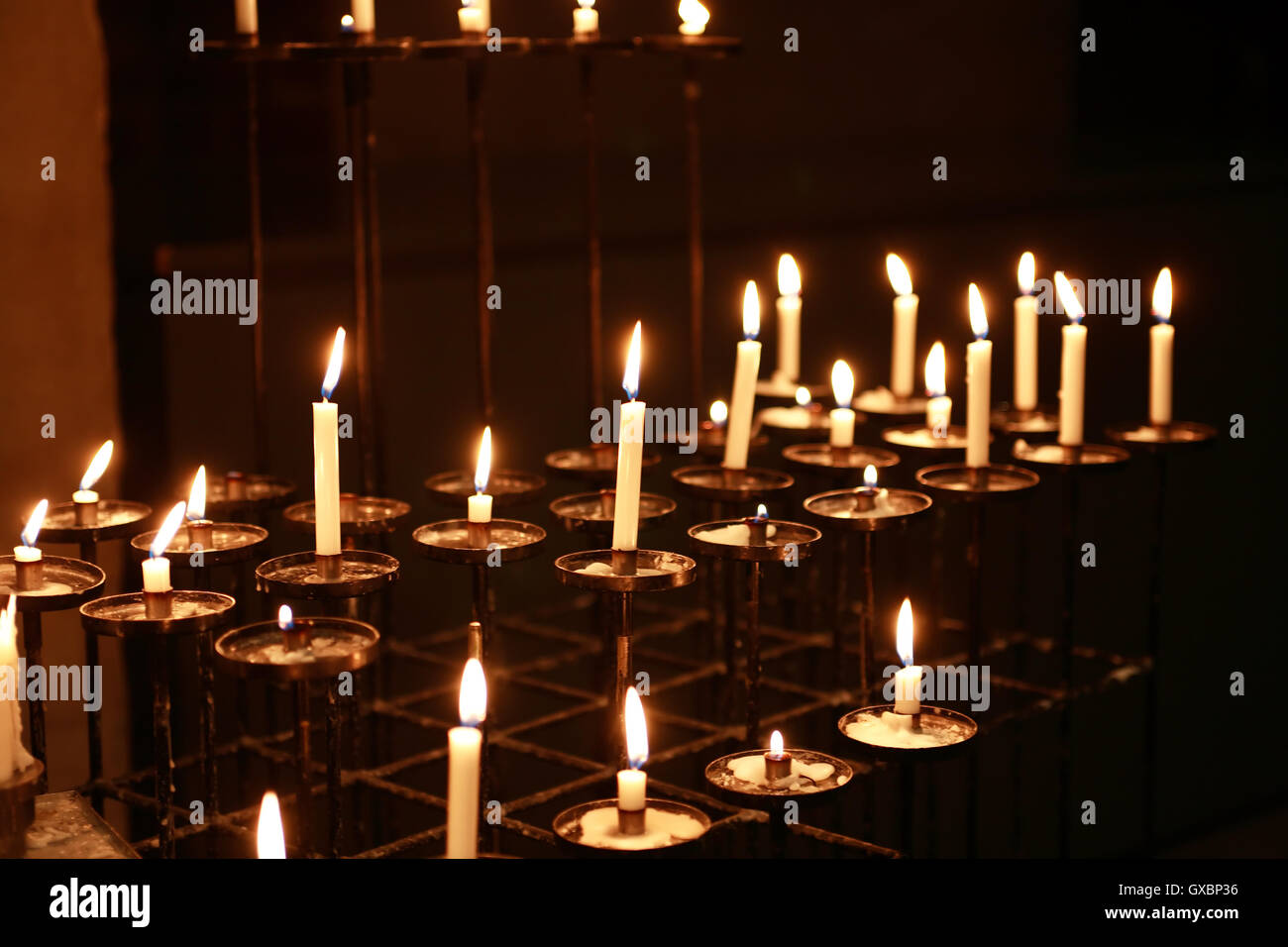 Religion concept. Set of lighting candles in church Stock Photo - Alamy