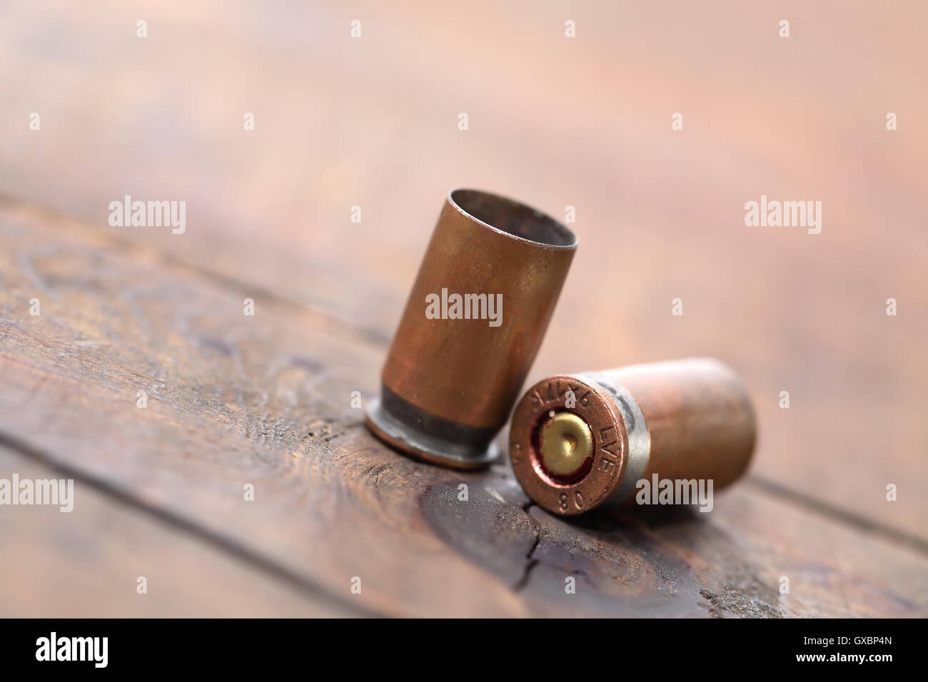 Pistol gun shells on wooden background with free space Stock Photo - Alamy