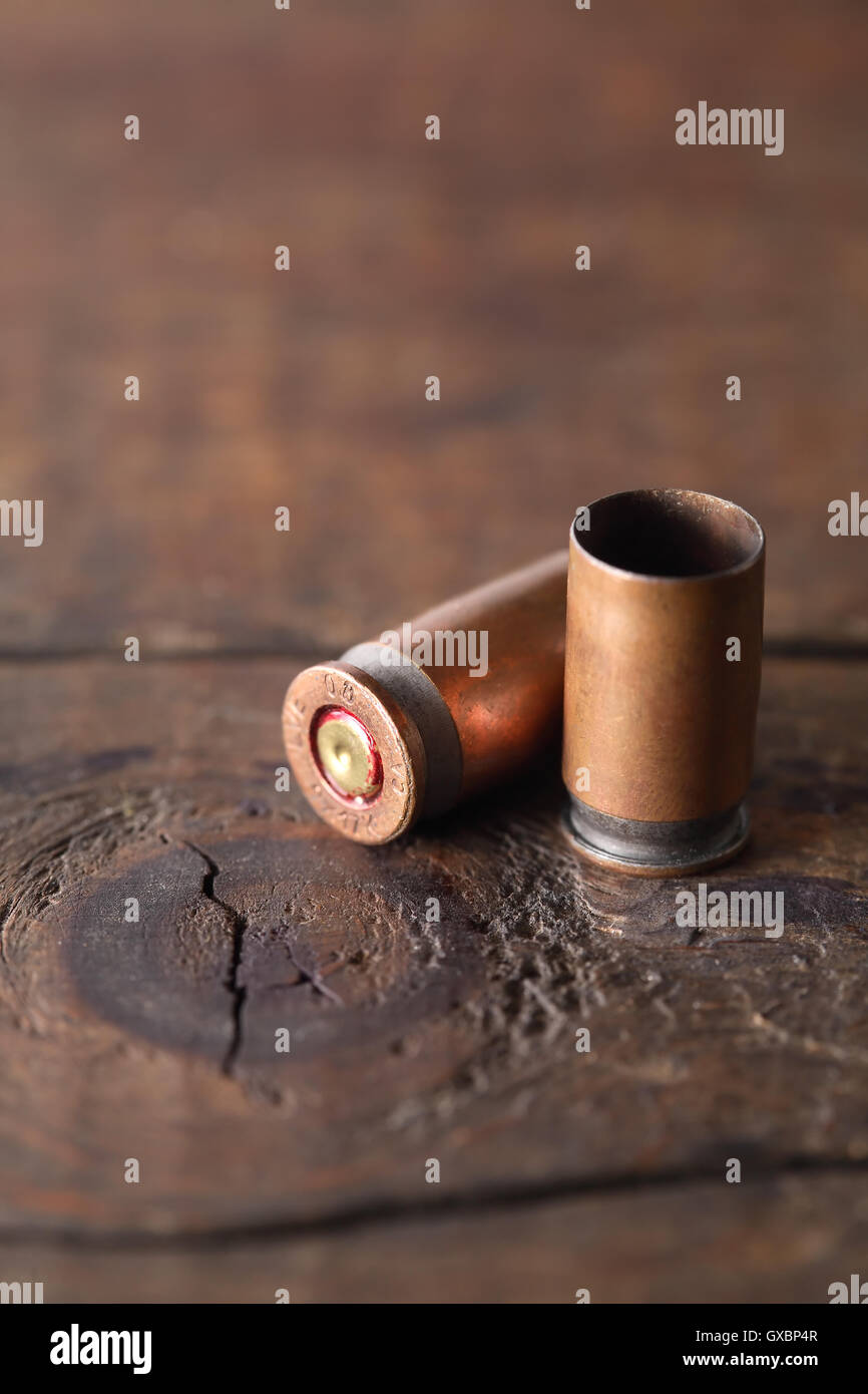 Pistol gun shells on wooden background with free space Stock Photo - Alamy