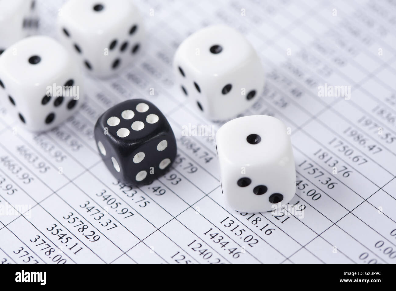 Business concept. Dice play on paper background with table of digits ...