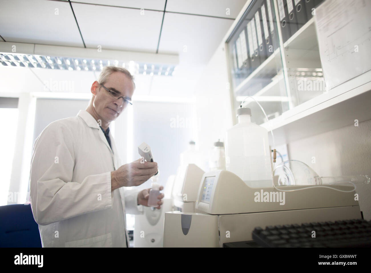 Male meteorologist examining equipment in weather station laboratory ...