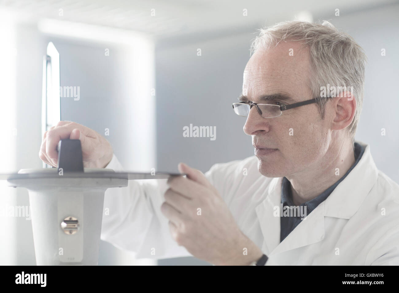Male meteorologist preparing equipment in weather station laboratory ...