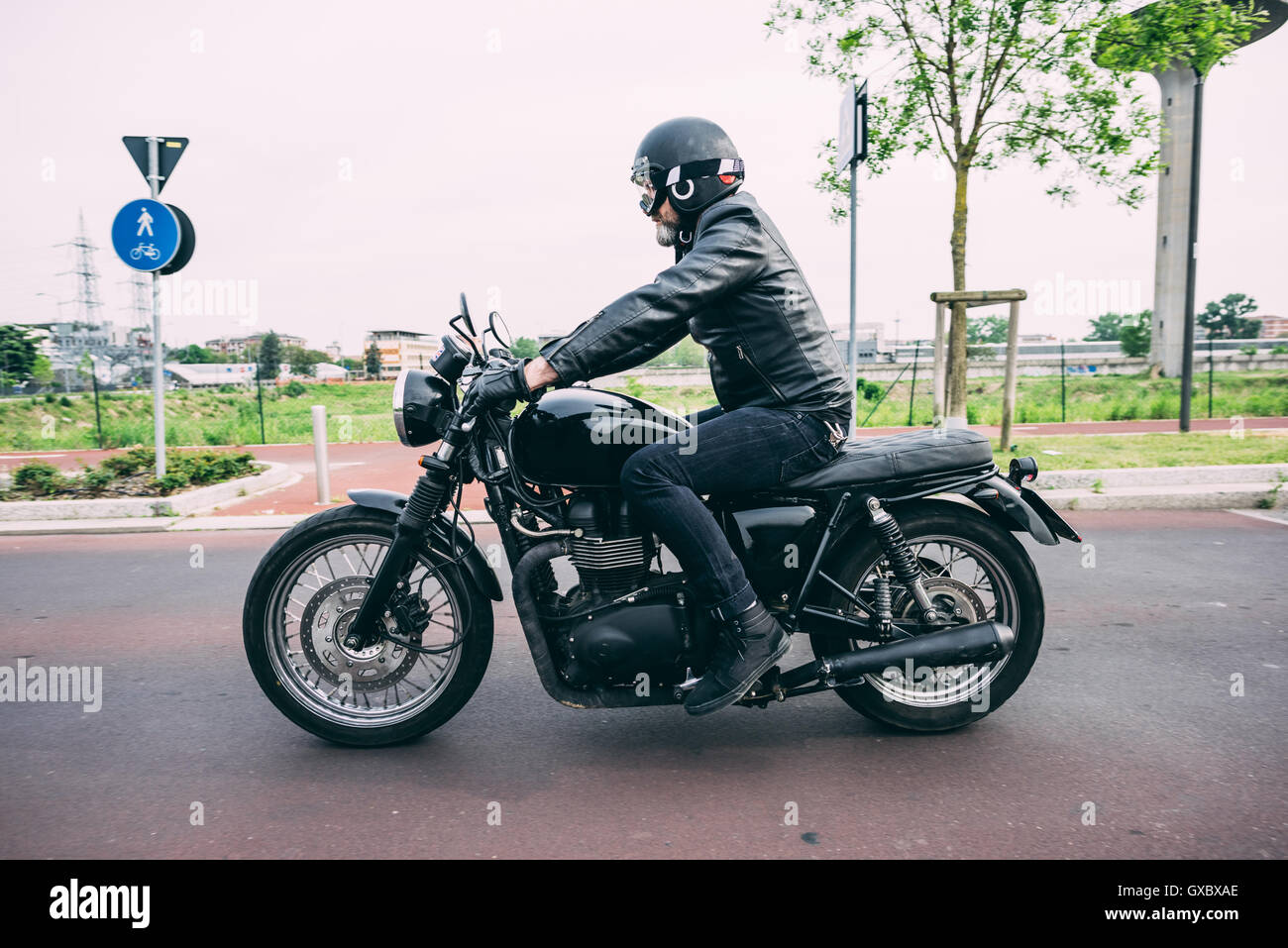 Male motorcyclist motorcycling on road Stock Photo - Alamy