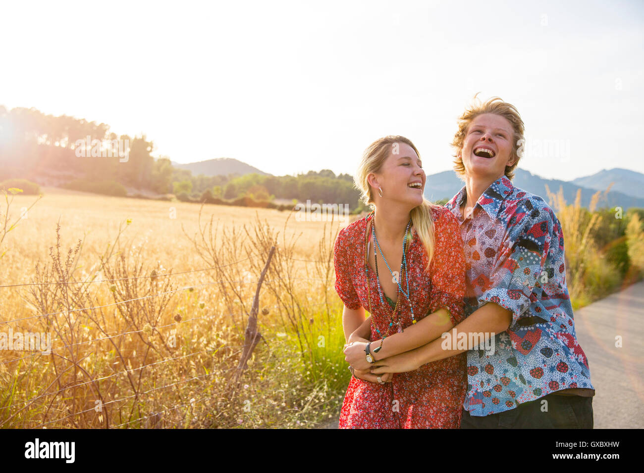 Young man hugging girlfriend on rural road, Majorca, Spain Stock Photo ...