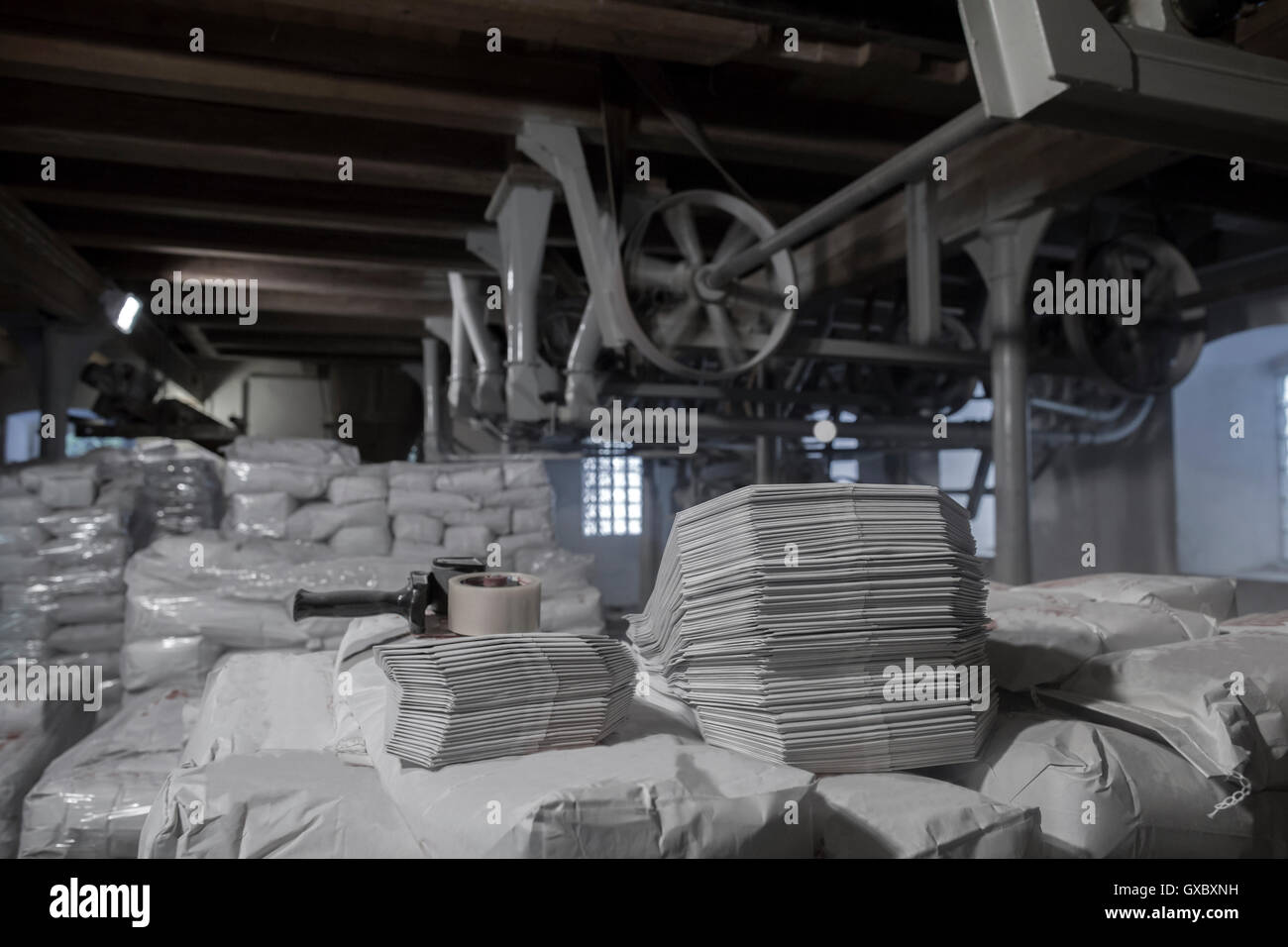 Milling machines and stacks of sacks in wheat mill Stock Photo - Alamy