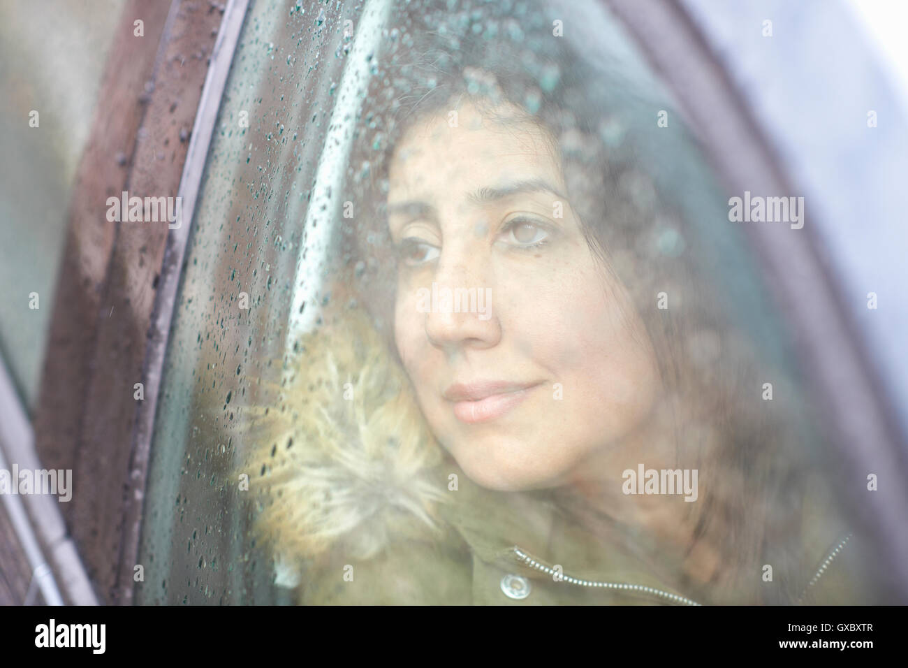 Woman looking through window rain hi-res stock photography and images ...