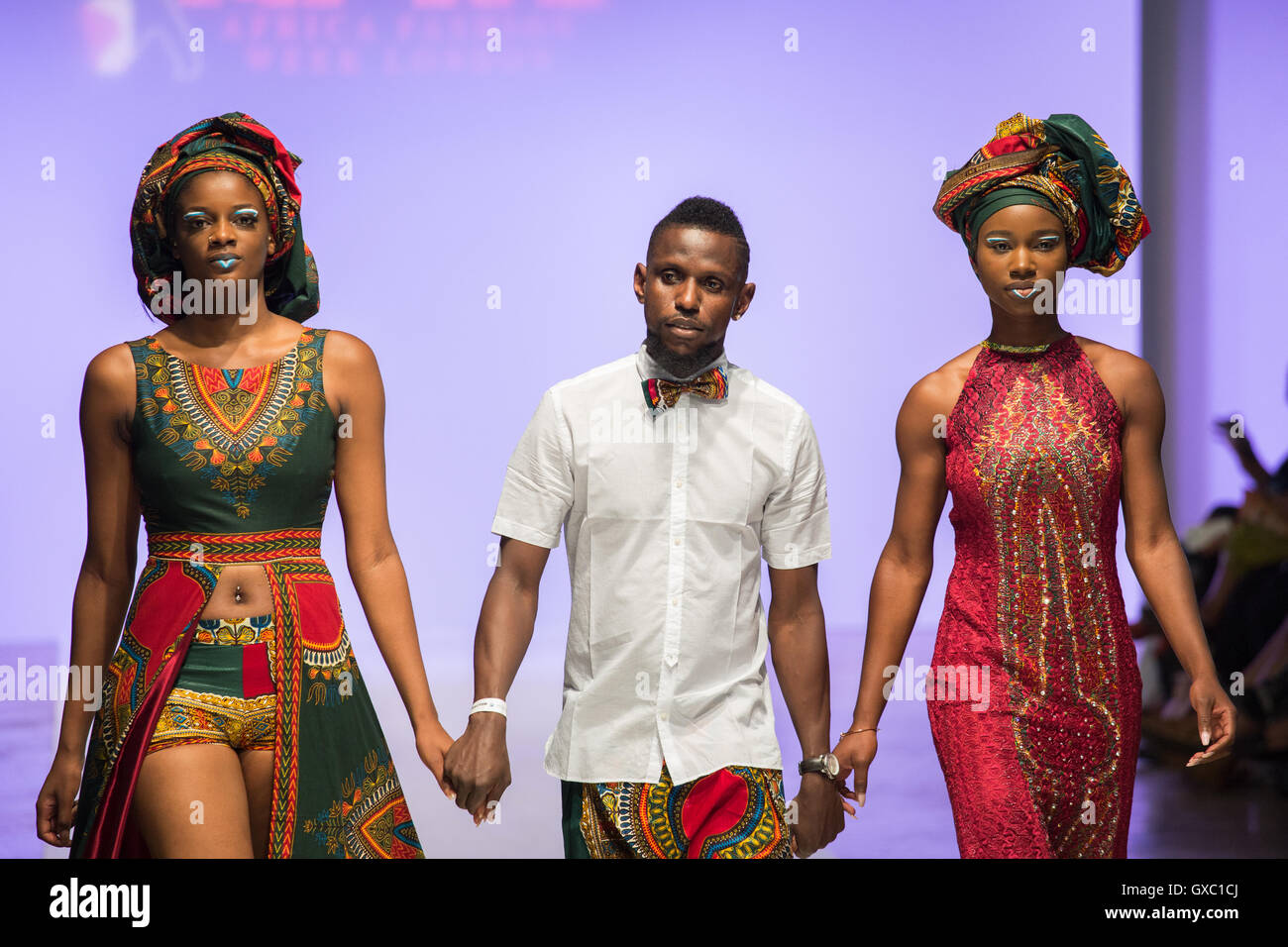 Africa Fashion Today designer walk down the runway with two models who ...