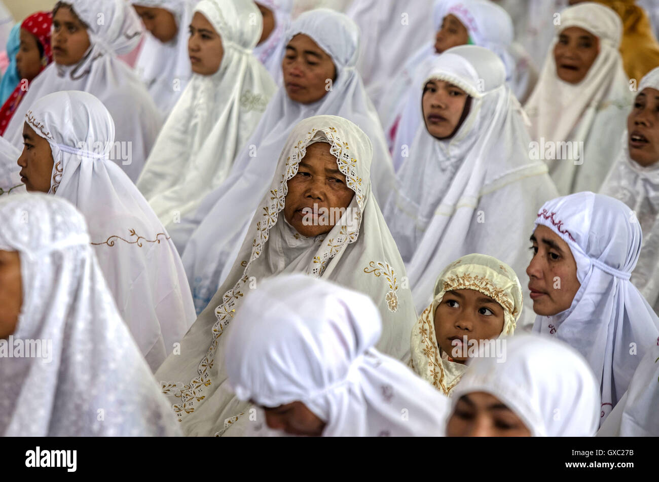 Indonesian Muslims perform Eid al-Fitr prayers near the Mount Sinabung ...
