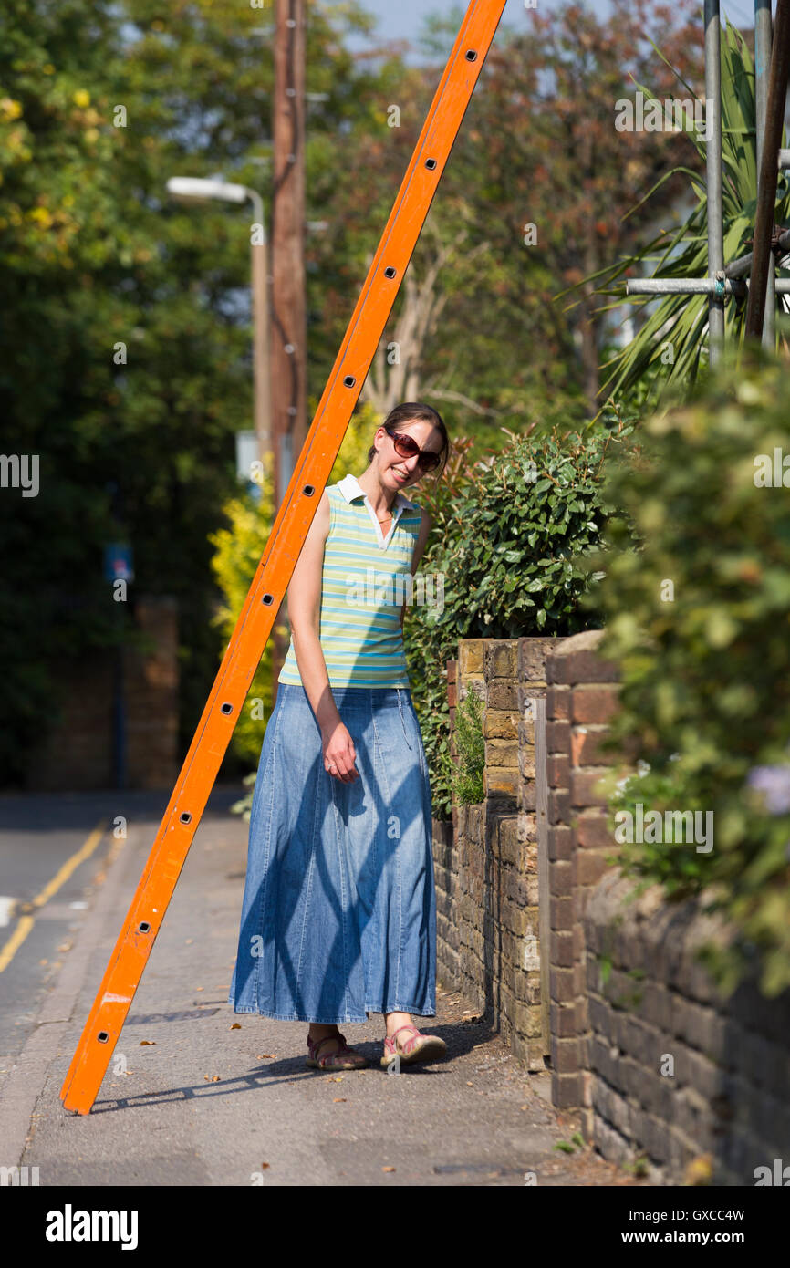 Pedestrian / lady / young woman / people / person walking under a ...