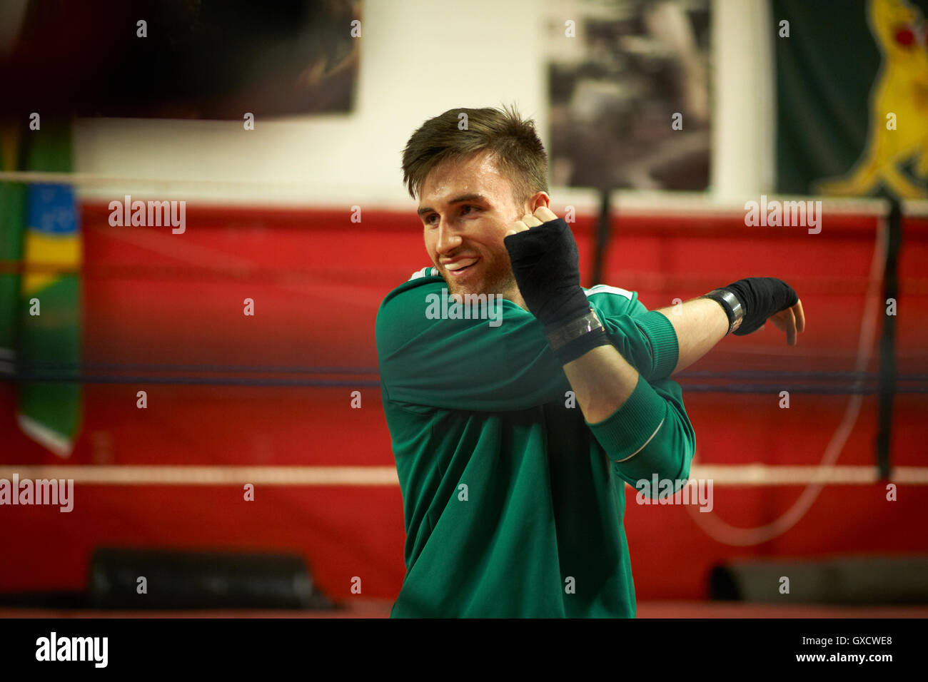 Young man exercising in boxing gym, stretching Stock Photo - Alamy
