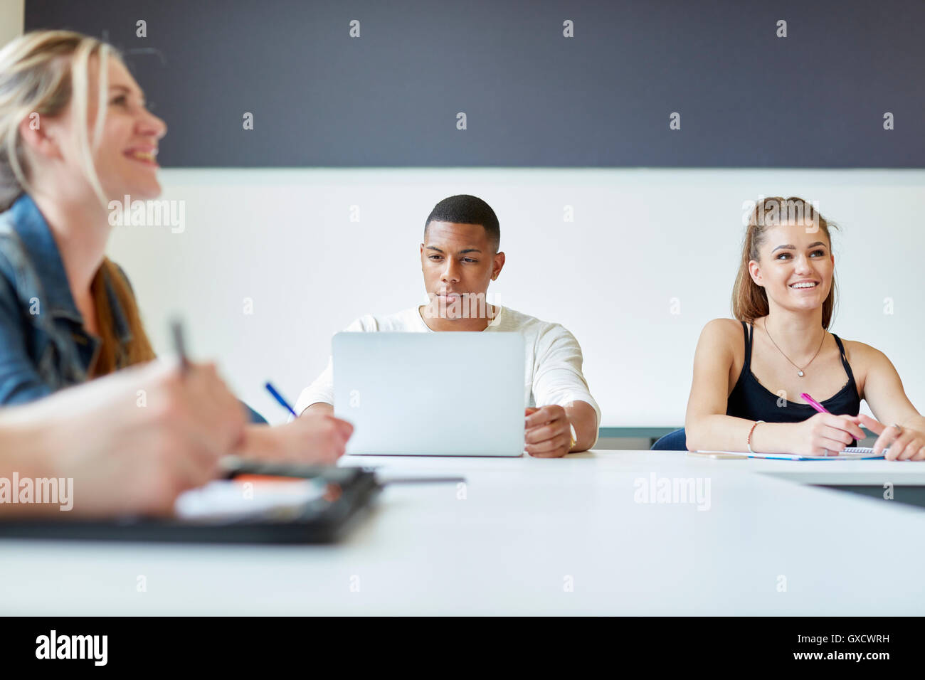 Students taking notes in higher education college classroom Stock Photo ...
