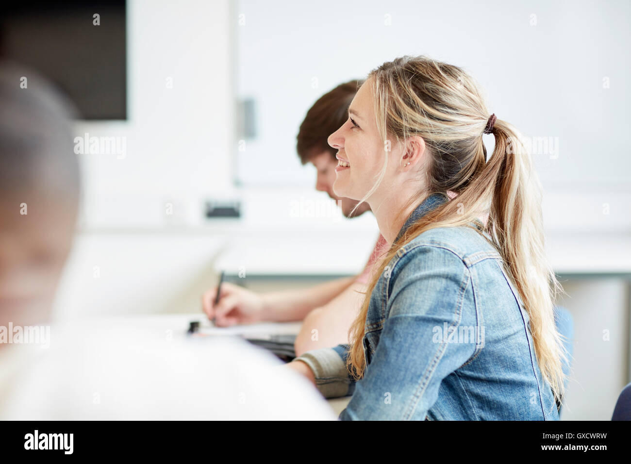 Female student listening in higher education college classroom Stock ...