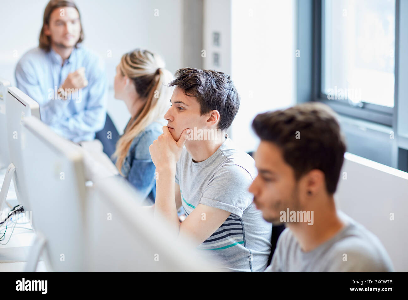 Students working on computers in higher education college computer room ...