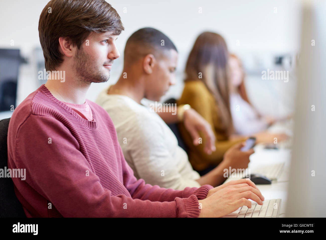 Young students using computers hi-res stock photography and images - Alamy
